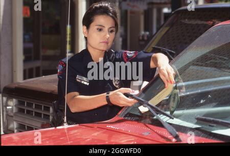 ©1997 Hispanic female police officer balances work with family life ...