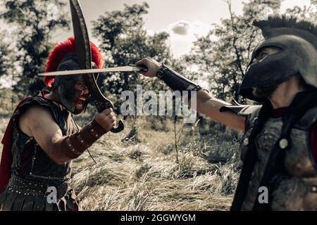 Battle with swords between two ancient greek or roman warriors in ...