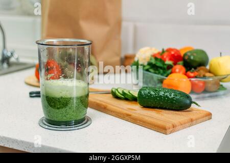 Spinach smoothie. Blended green smoothie with ingredients on black ...