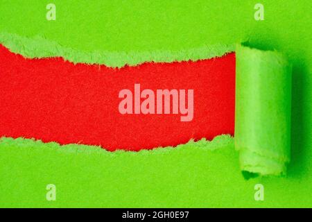 Red paper torn to reveal green panel ideal for copy space Stock Photo ...