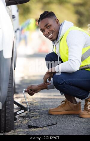 handsome young man lifting the car Stock Photo - Alamy