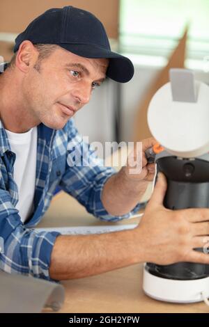 mature man repairing broken coffee machine Stock Photo - Alamy