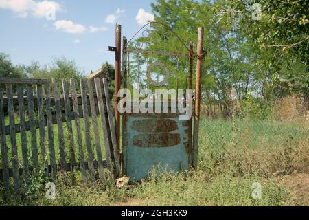 old rickety gates. Old rusty gate in an abandoned house. Broken gate ...