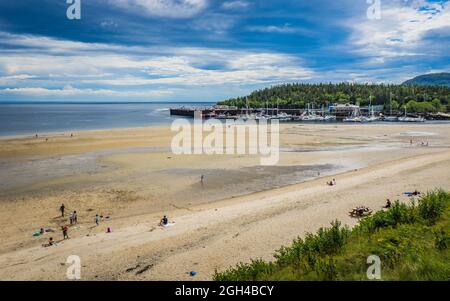 The sandy beach and marina of the Tadoussac Bay on a beautiful summer ...