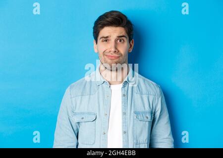 Portrait of awkward and uncomfortable caucasian bearded man, smirk and ...