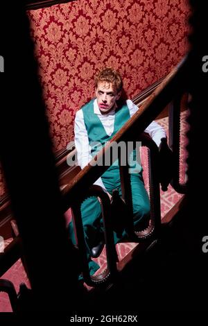 Eccentric male actor with smeared makeup shouting with anger while ...