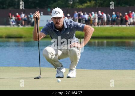 Sam Burns lines up his putt on the third green during the second round ...