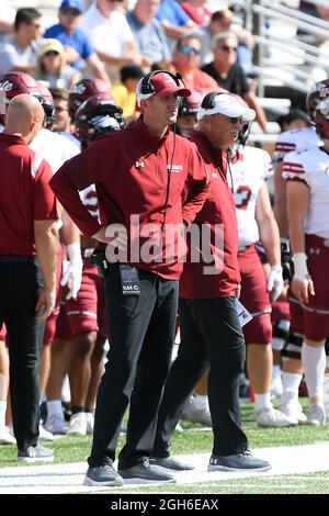 Colgate head coach Stan Dakosty, right, walks on the field during the ...
