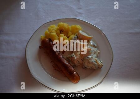 Berner Würstchen with potatoes and zucchini salad Stock Photo - Alamy
