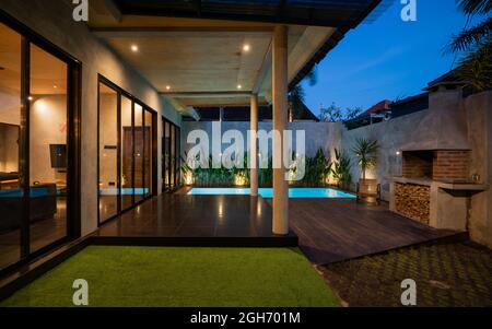 Trendy outdoor modern house, pool, garden lounge, chairs, metal grill ...