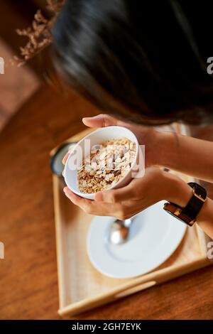 Breakfast, a cup of oatmeal with nuts and raisins, a cup of hot black ...