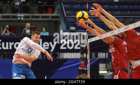 Jan Galabov, left, of the Czech Republic hits the ball against Tunisia ...