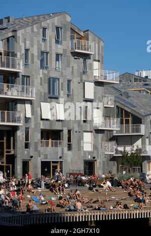 People swimming in the Norwegian Sea and sunbathing on the beach off ...