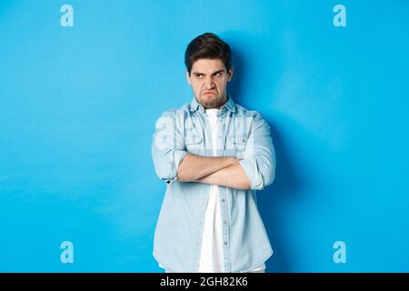 Angry guy cross arms on chest and looking away with insulted expression ...