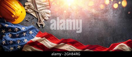 Labor Day concept. American flag and construction tools on dark ...