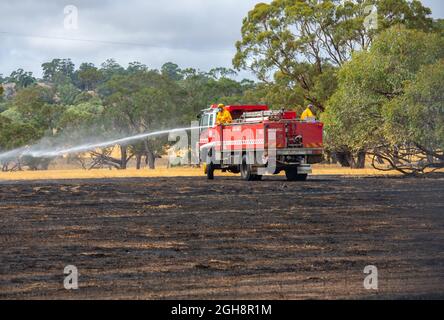 A fire appliance putting out a grass fire, Langley Barfold, Victoria ...