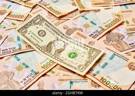 US dollar banknote and Uzbek sums. Concept of exchange rate, Uzbek sum ...