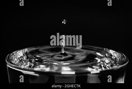 Rain drops bounce & splash in puddles during heavy rain storm causing ...