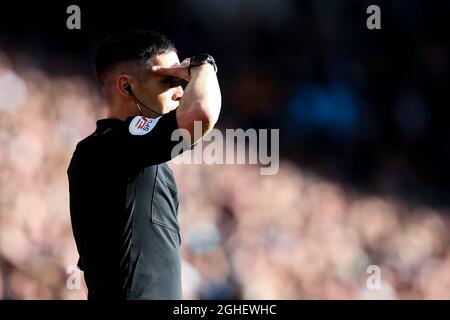 The assistant referee shields his eyes from the sun Stock Photo - Alamy