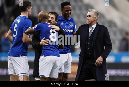 Everton manager Carlo Ancelotti embraces with his players during the ...