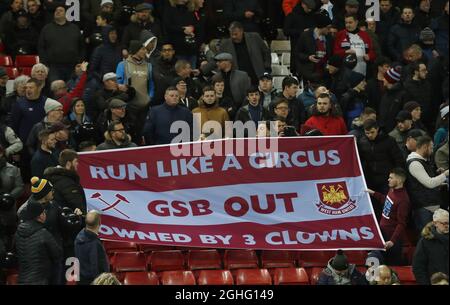 West Ham fans holding up red cards with No More BS on them during the ...