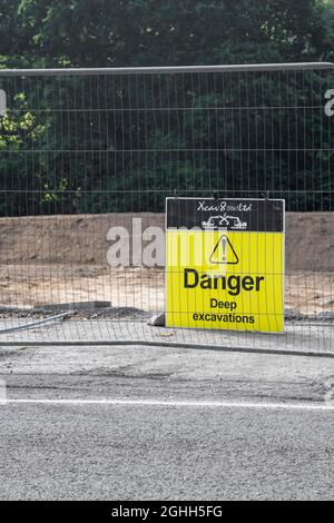 yellow warning sign for deep excavations Stock Photo - Alamy