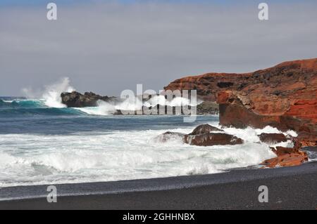 Red and black sand on ava beach on Lanzarote, Spain Stock Photo - Alamy