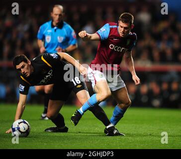 Gareth Barry of Manchester City tussles with Joey Barton of QPR ...