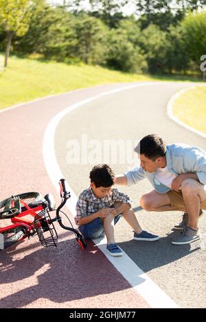 Little boy falling off his bike Stock Photo - Alamy