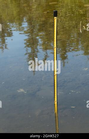 Depth stick for measuring the water level in a river Stock Photo - Alamy