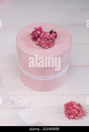 Round pink gift box with roses on wooden board celebrations concept ...