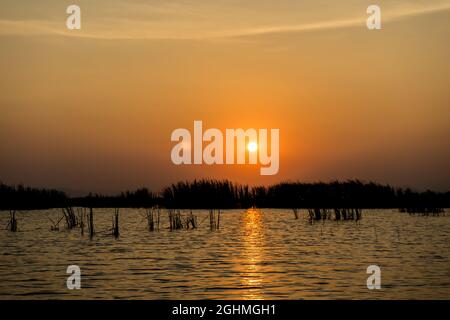 Beautiful view of the wavy lake gleaming under the shiny sunrays during ...