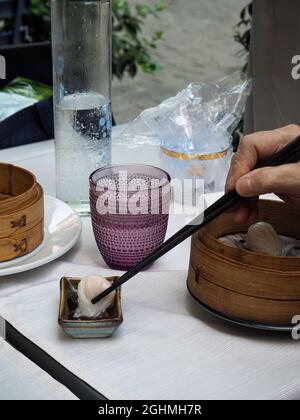 Senior man eating Chinese dumpling outdoors Stock Photo - Alamy
