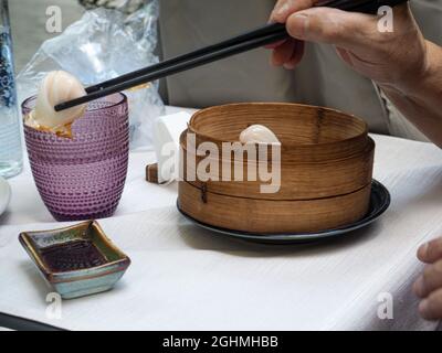 Senior man eating Chinese dumpling outdoors Stock Photo - Alamy
