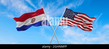 two crossed flags Paraguay and United Arab Emirates waving in wind at ...