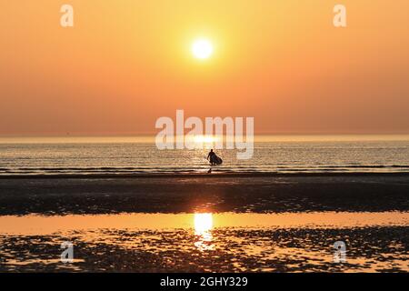 A paddle boarder takes a dip in the Irish Sea at Blackpool sea front ...