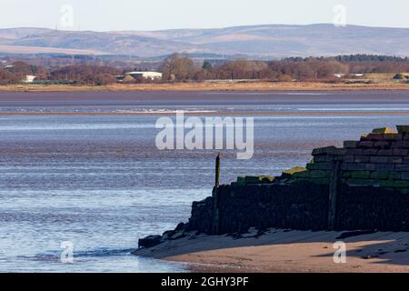 The Solway Bore passing the old harbour at Port Carlisle Stock Photo ...
