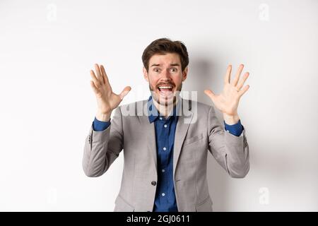 Businessman scream and shake hands in panic, look alarmed and anxious ...