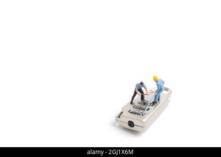 Miniature people worker : Teamwork helps to unlock password on the keys ...