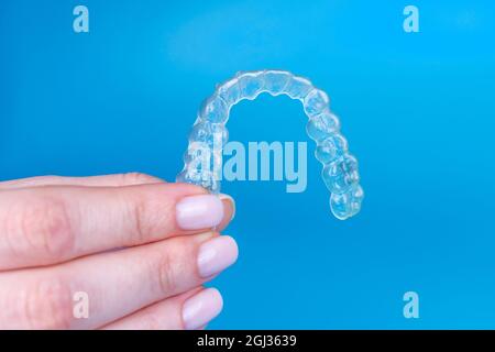 Hand holding removable invisible transparent aligner invisalign or ...