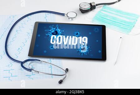 Tablet pc and doctor tools on white surface Stock Photo - Alamy