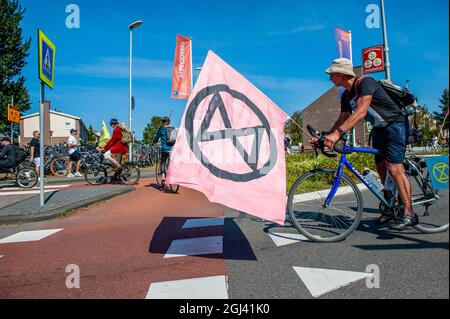Extinction Rebellion activists are riding with their bikes around the ...