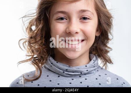 Cute little girl with a charismatic grin isolated on white Stock Photo ...