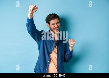 Lucky man celebrating victory, cheering and shouting yes with joy ...