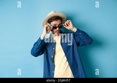Image of tourist checking out something cool, take-off sunglasses, say ...