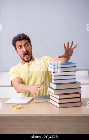 Screaming young teacher in classroom. Angry female teacher at ...
