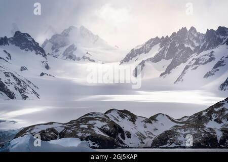 Antarctica, South Georgia Island, Coopers Bay. Iceberg with arch at sunrise Credit as: Don Grall ...