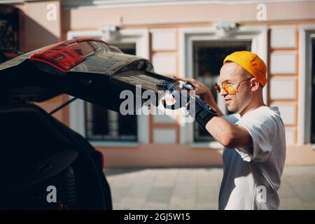Hand closing car trunk Stock Photo - Alamy