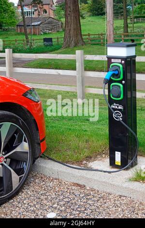 Close up of electric car with a connected charging cable Stock Photo ...