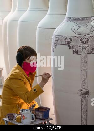 Woman painting a pottery vase Stock Photo - Alamy